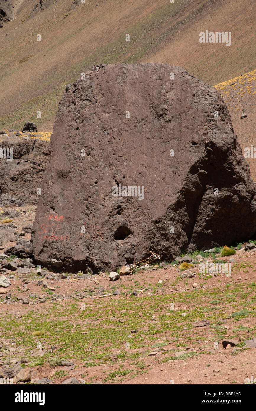 Natural rock boulder sitting at the bottom of the valley in the Andes ...
