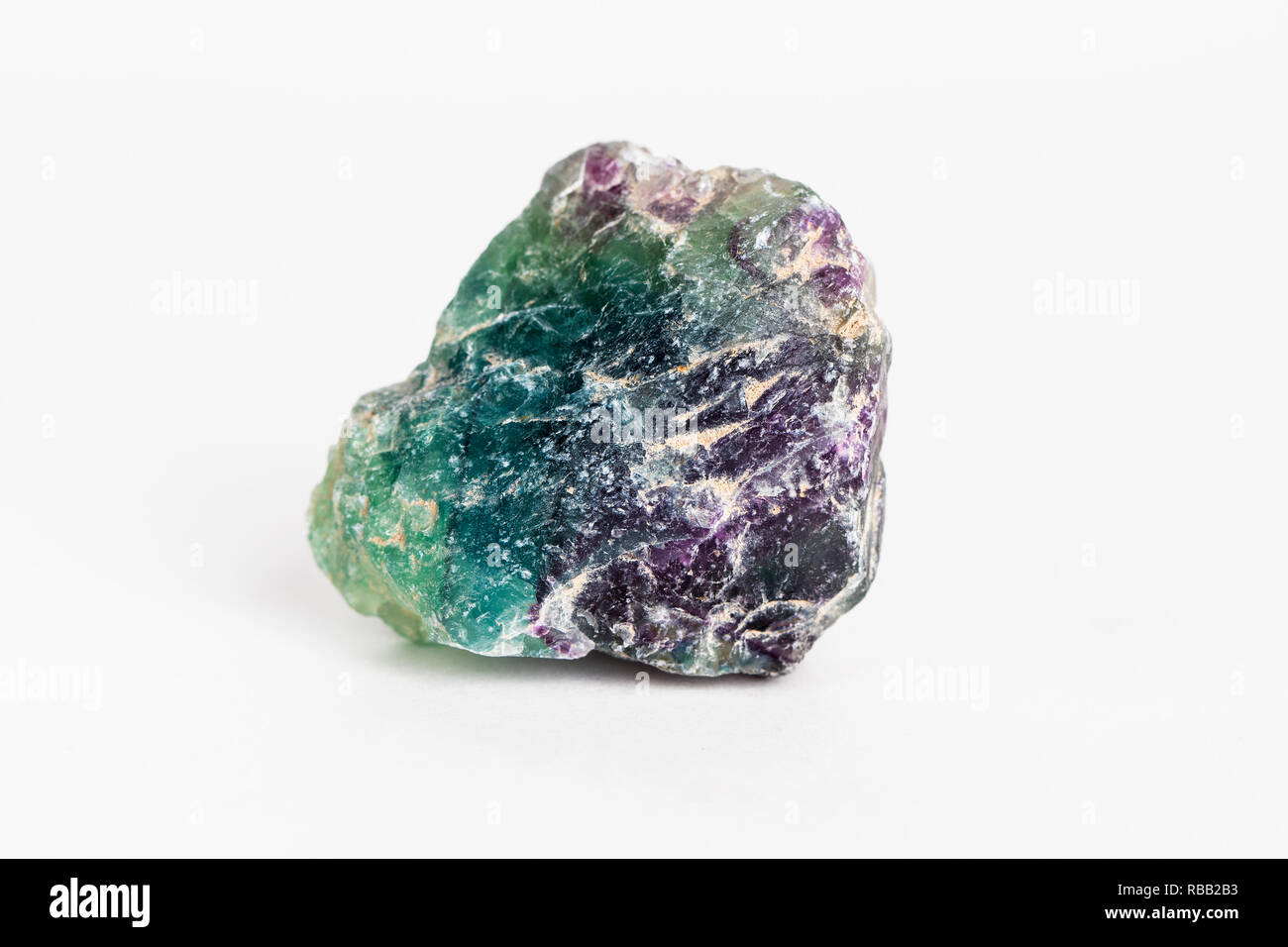 Macro of mineral stone fluorite crystal in a close-up on white ...
