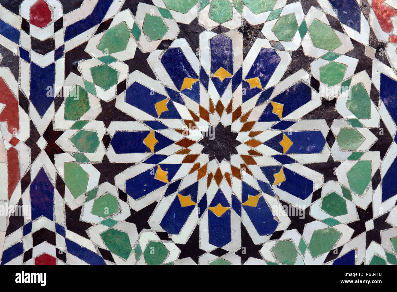Close up Moroccan tile with red, blue, black, white, green, yellow and ...