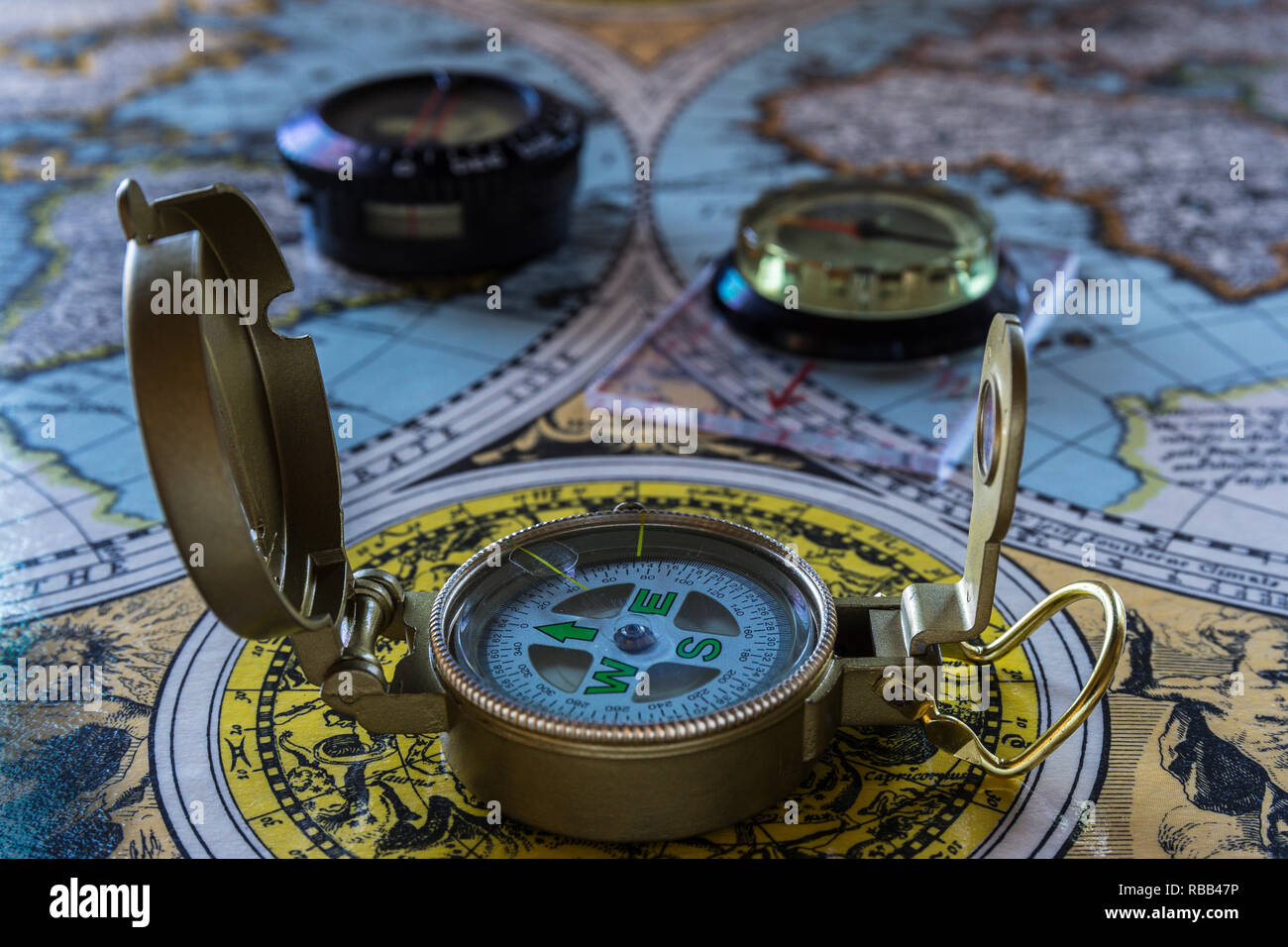compasses on old world map as concept Stock Photo - Alamy