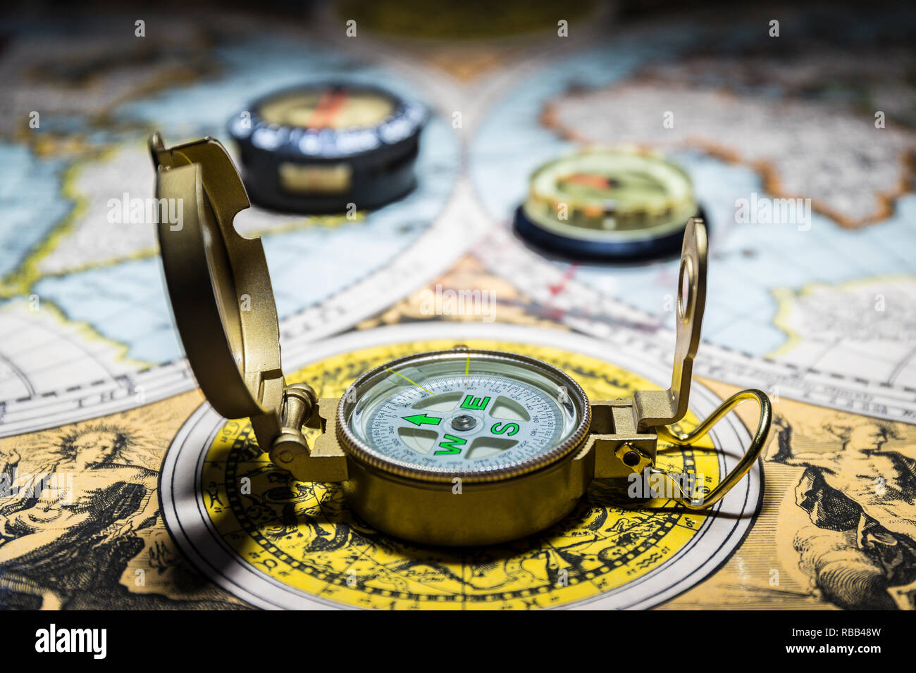 compasses on old world map as concept Stock Photo - Alamy