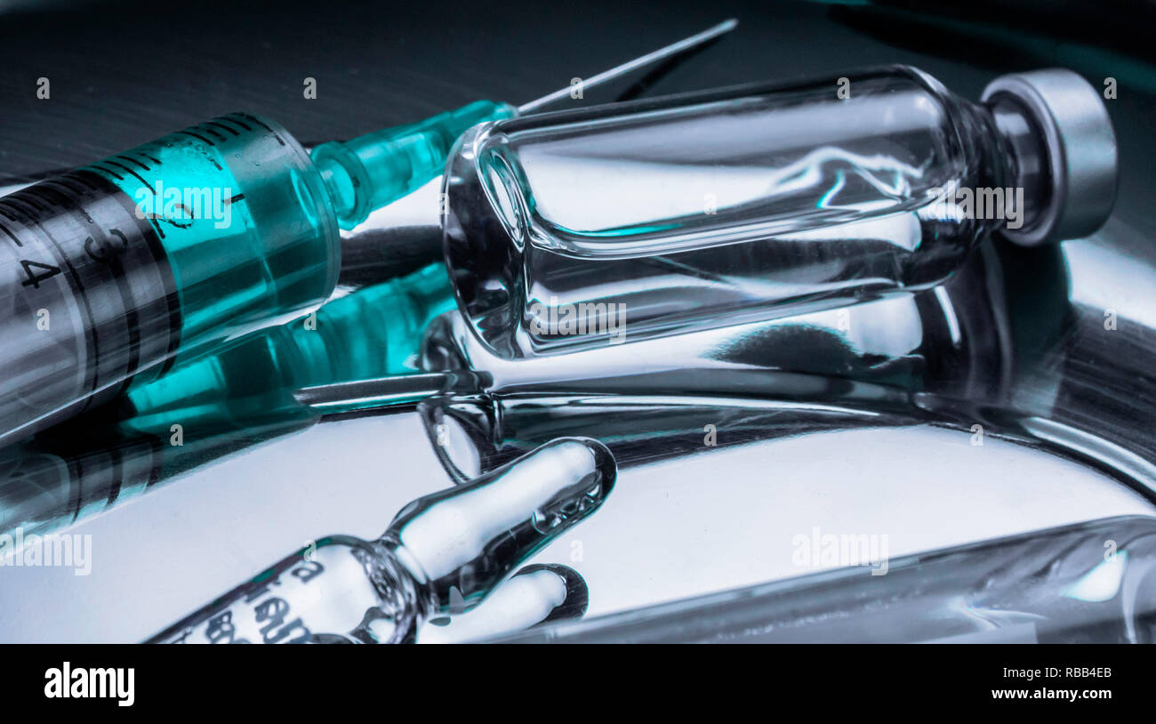 Several vials and syringe in laboratory, conceptual image Stock Photo - Alamy