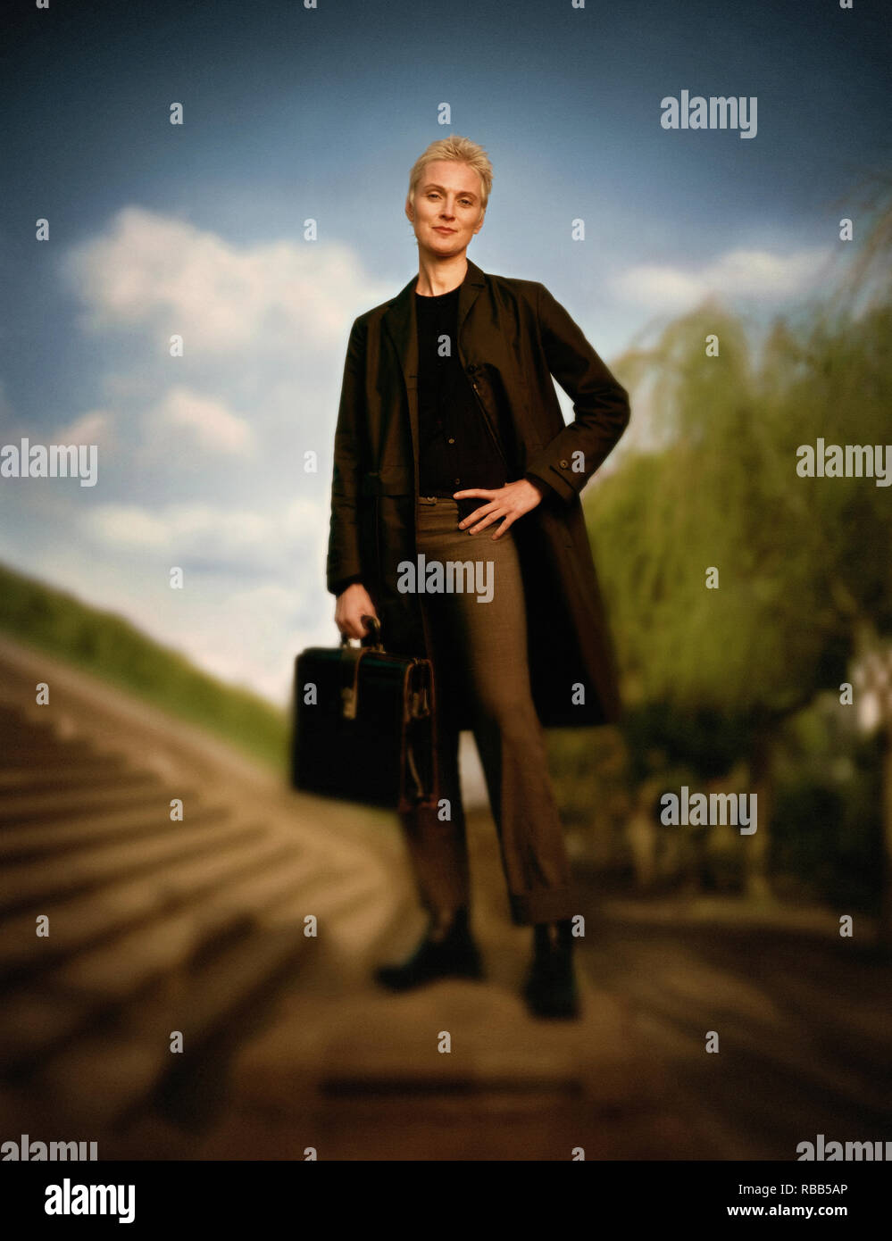 Front view of a young woman carrying a bag Stock Photo - Alamy