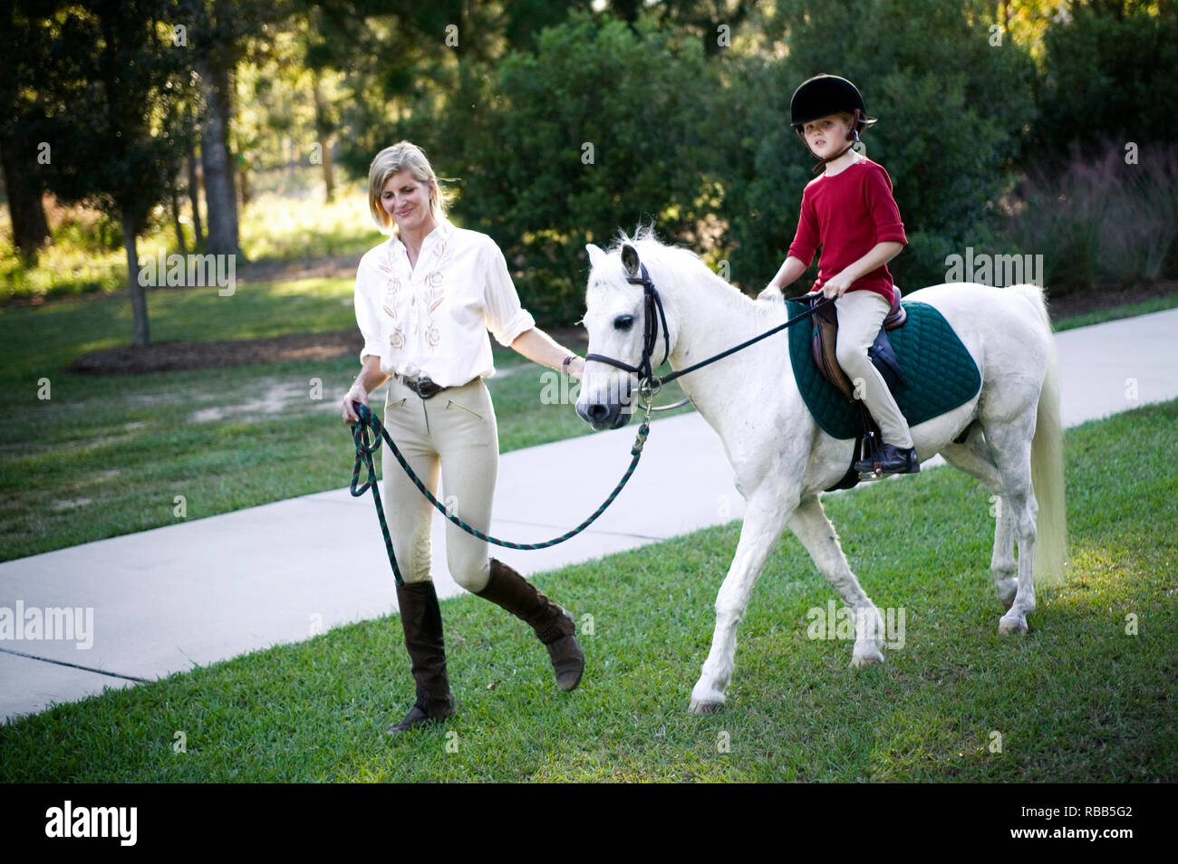 Woman rides pony hi-res stock photography and images - Alamy