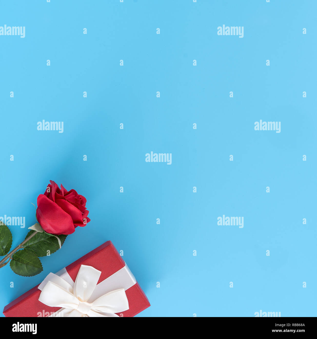 Red gift box with white ribbon bow and rose, concept of Valentine's day ...