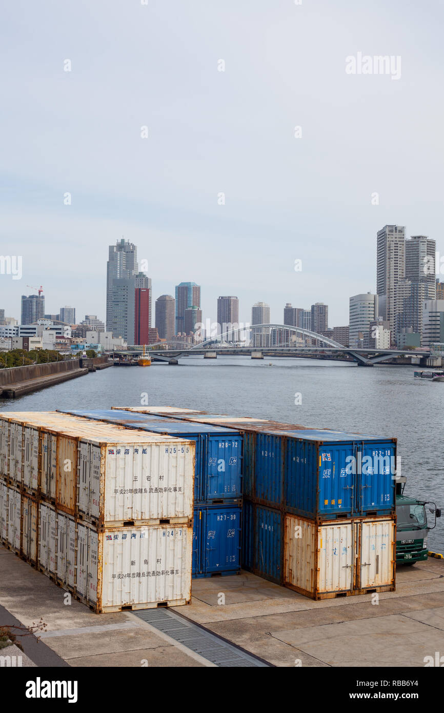 shipping containers in foreground, Tsukiji bridge in background. Tokyo ...