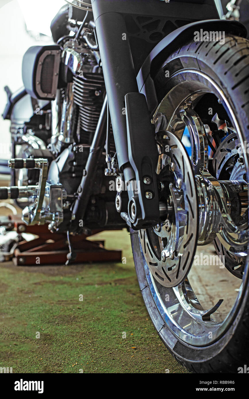 Cropped close up shot of beautiful and custom made motorcycle in the ...