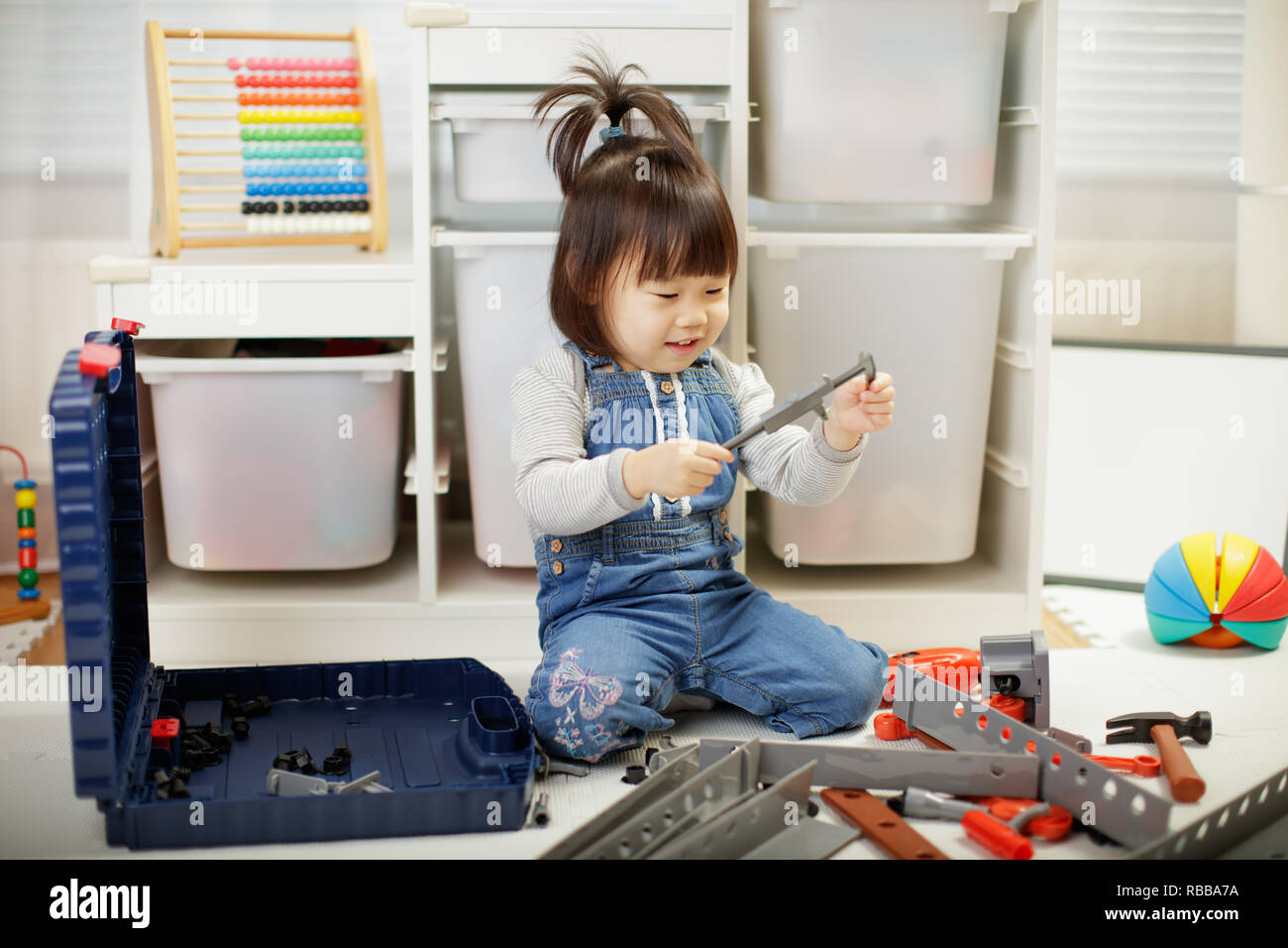 toddler baby girl pretend play DIY tools at home Stock Photo - Alamy