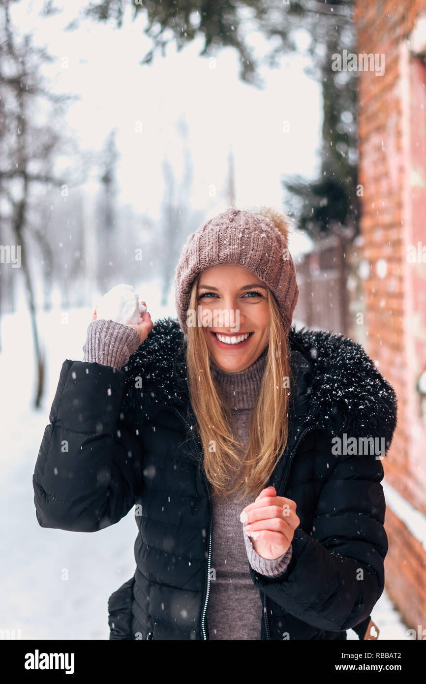 Woman throwing snowballs at Winter Stock Photo - Alamy