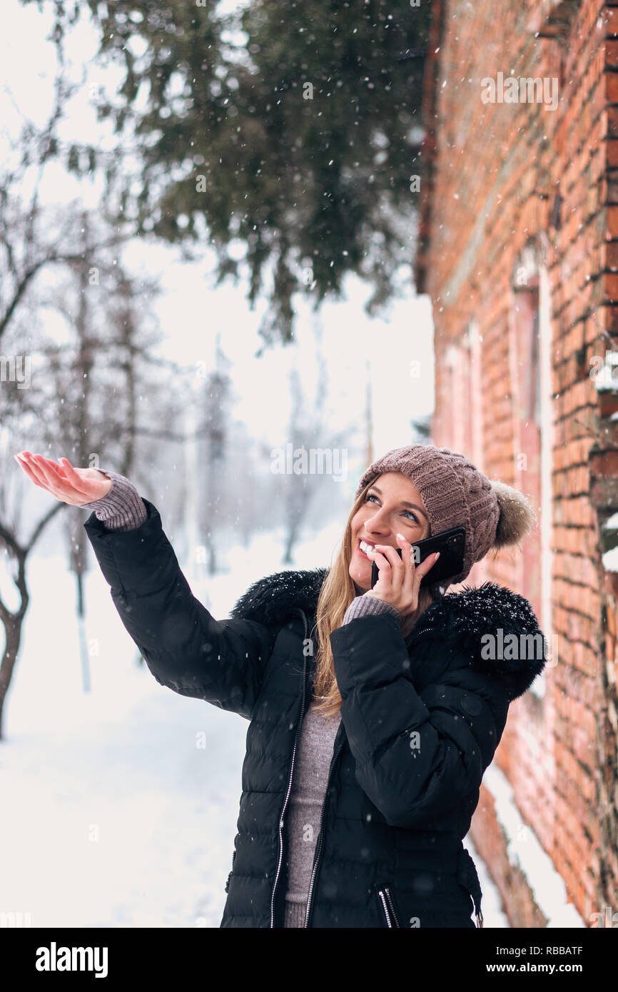 Talking on phone outdoors while snow falling Stock Photo - Alamy