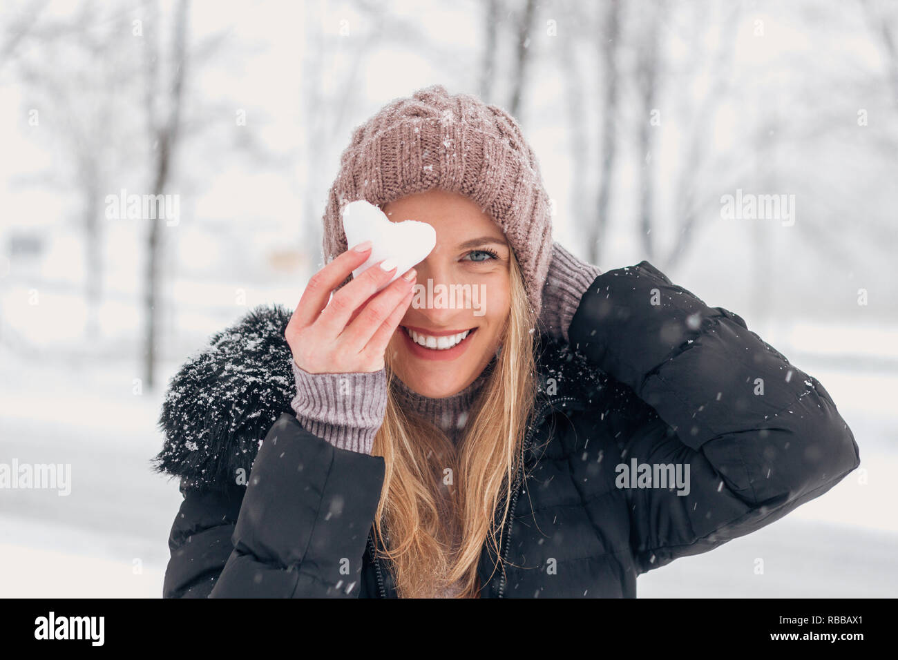 Woman covered her eye with snow Stock Photo - Alamy