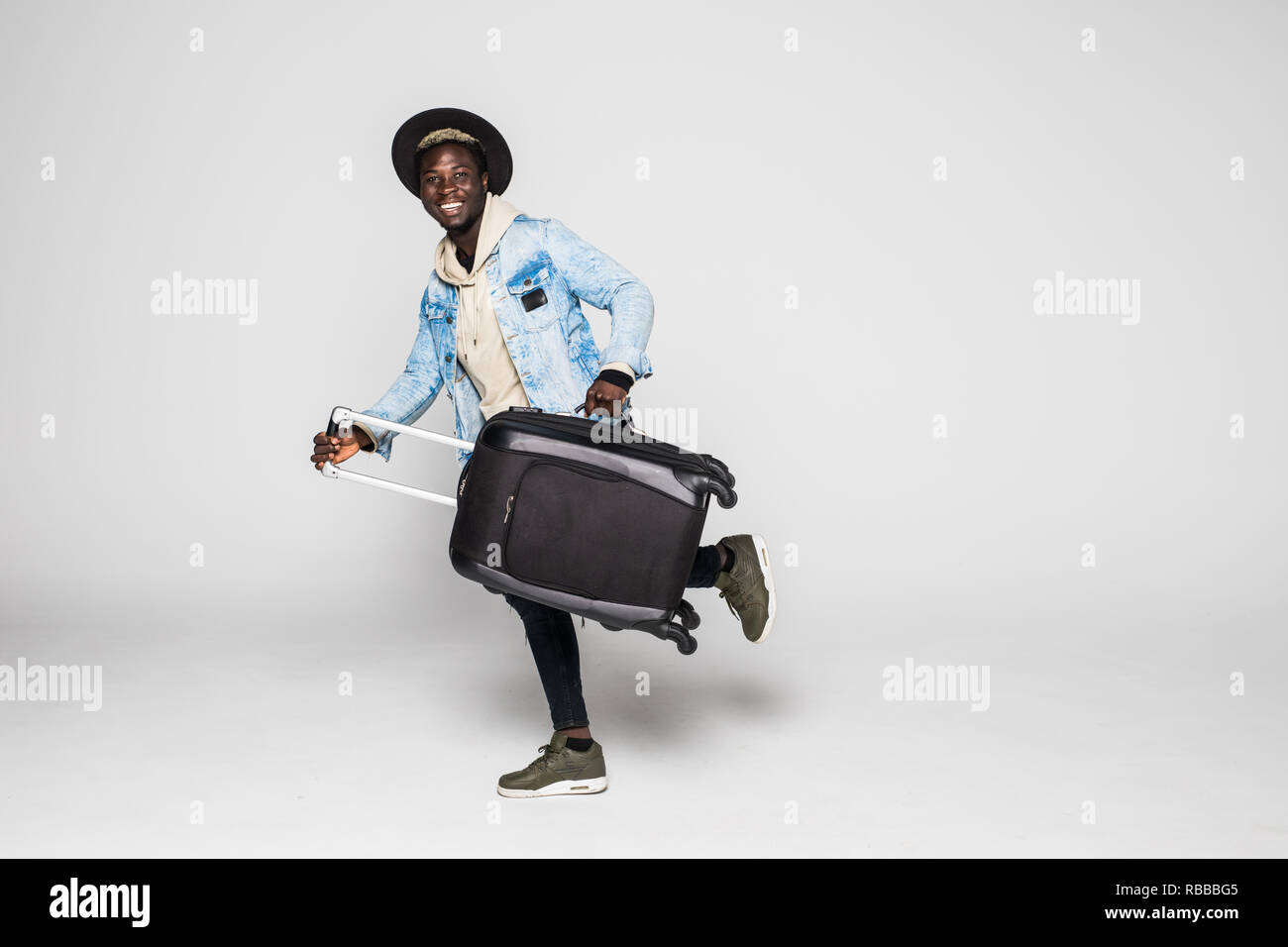 African Tourist running fast over white background Stock Photo - Alamy