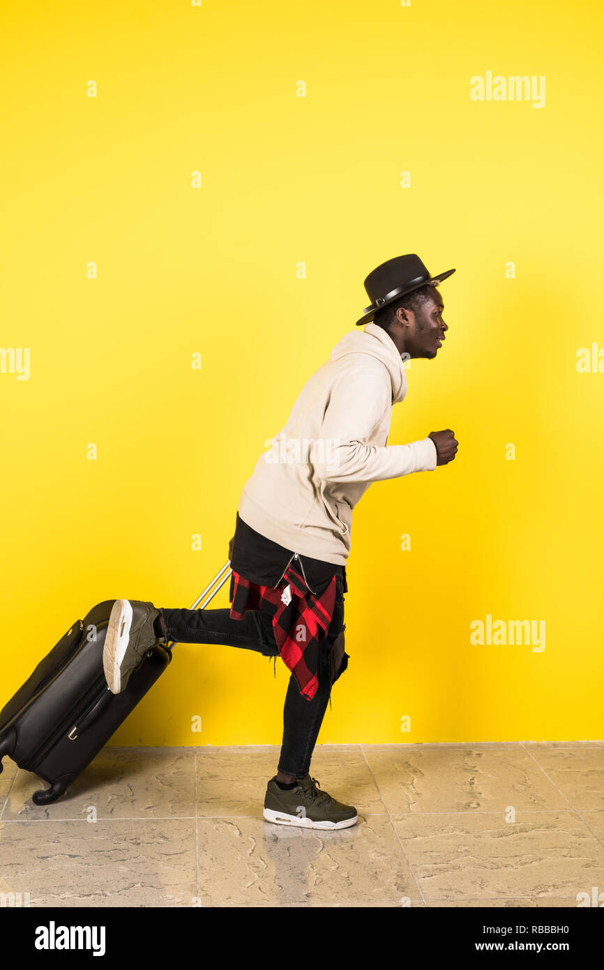 African Tourist man running fast over yellow background Stock Photo - Alamy