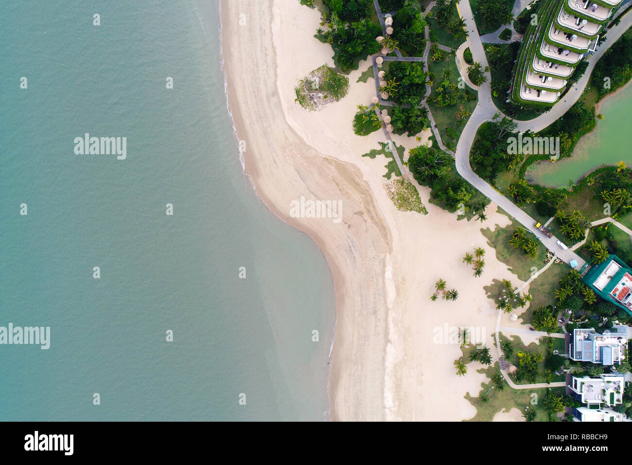 Aerial view of sandy beach , ocean with waves and beautiful resort ...