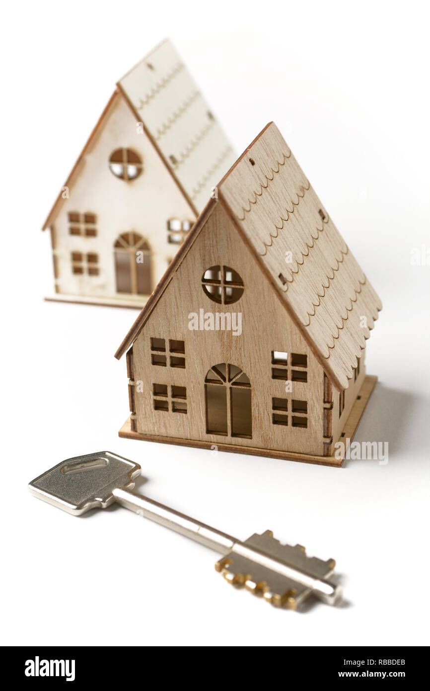 small model of house on a white background with keys to the side ...