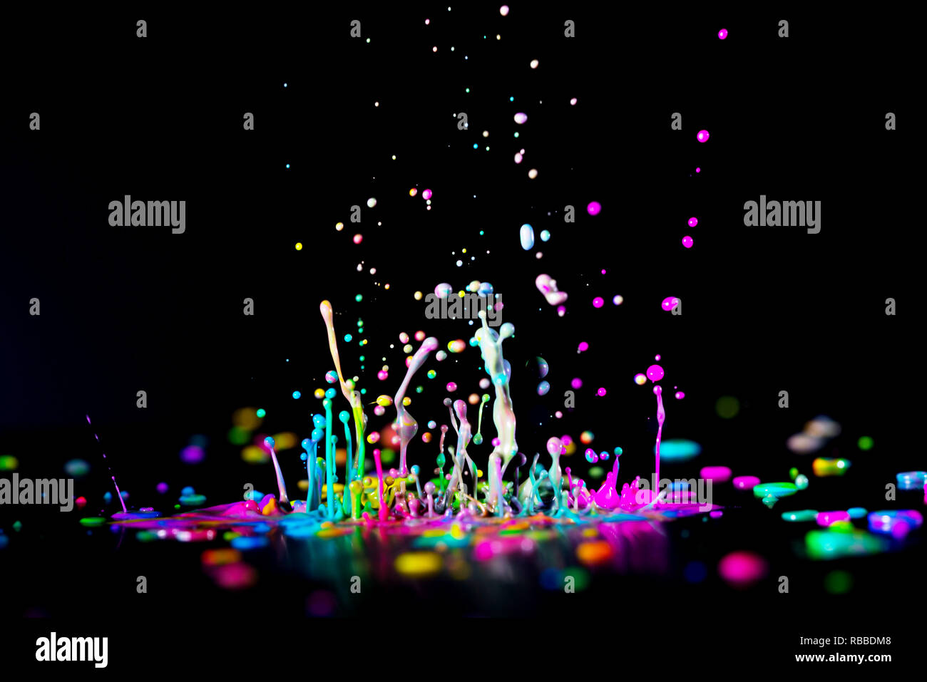 Abstract sculptures of colorful splashes of paint. Dancing liquid on a ...