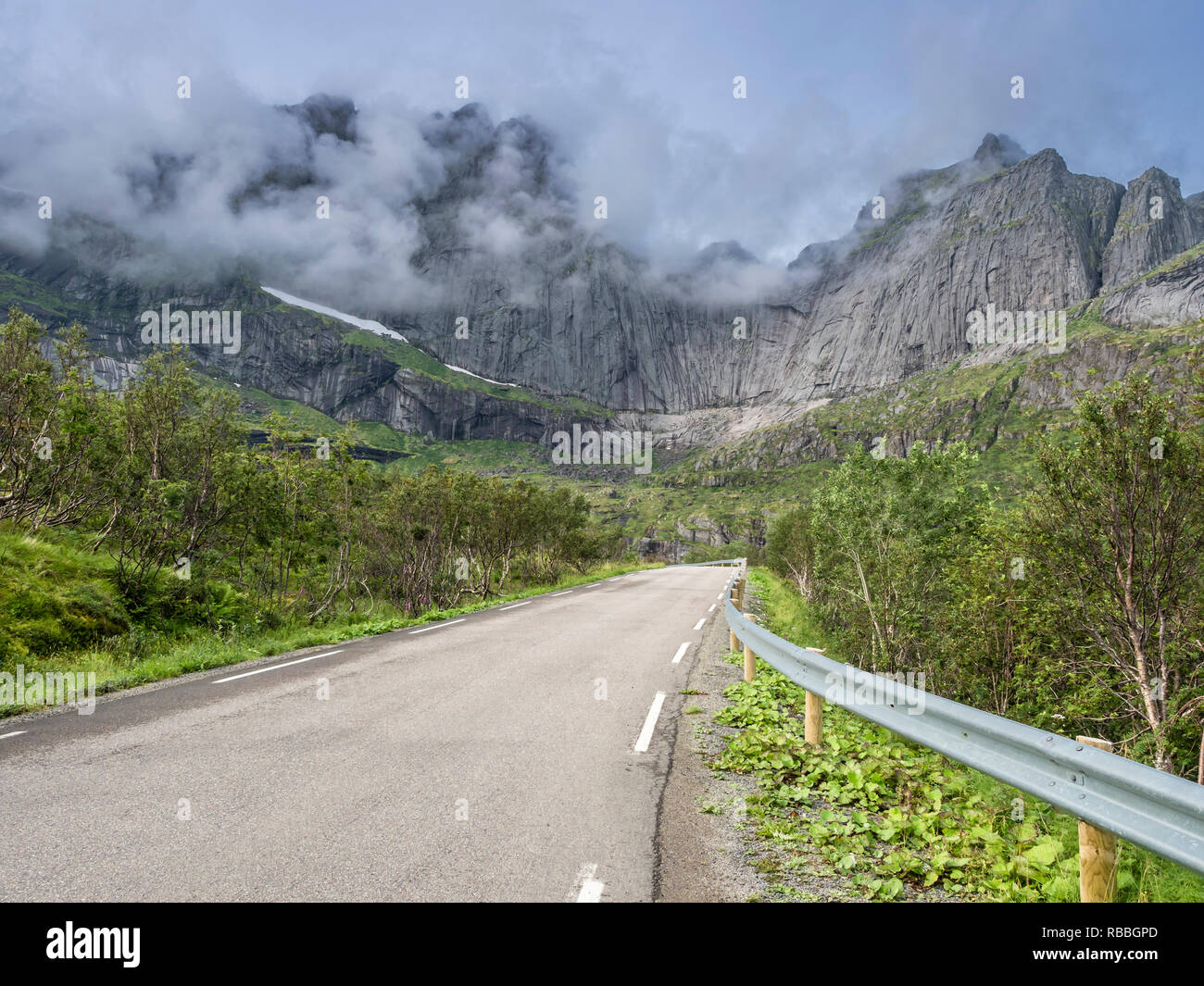 Steep granite cliffs at the road to Nusfjord, narrow single track road ...