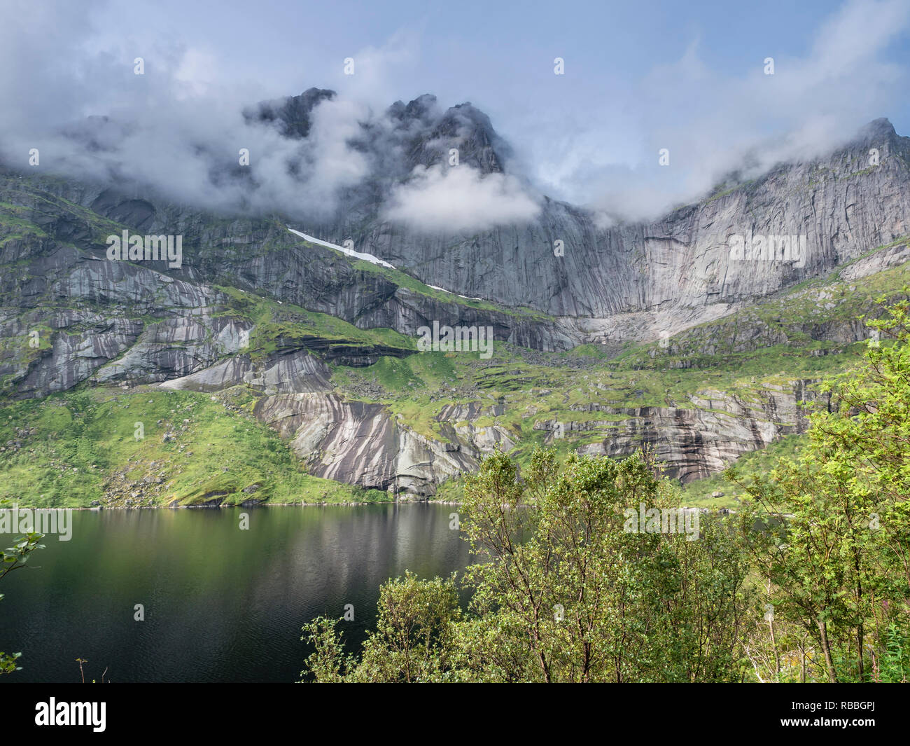 Steep granite cliffs at the road to Nusfjord, narrow single track road ...