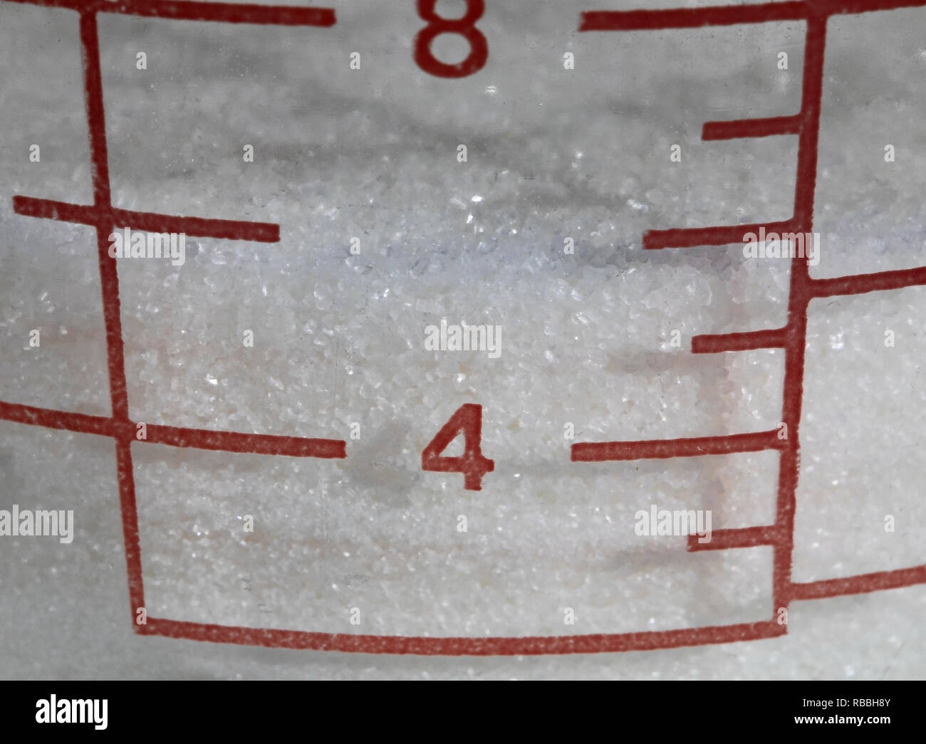 Closeup of measuring marks for white cane sugar in cup Stock Photo - Alamy