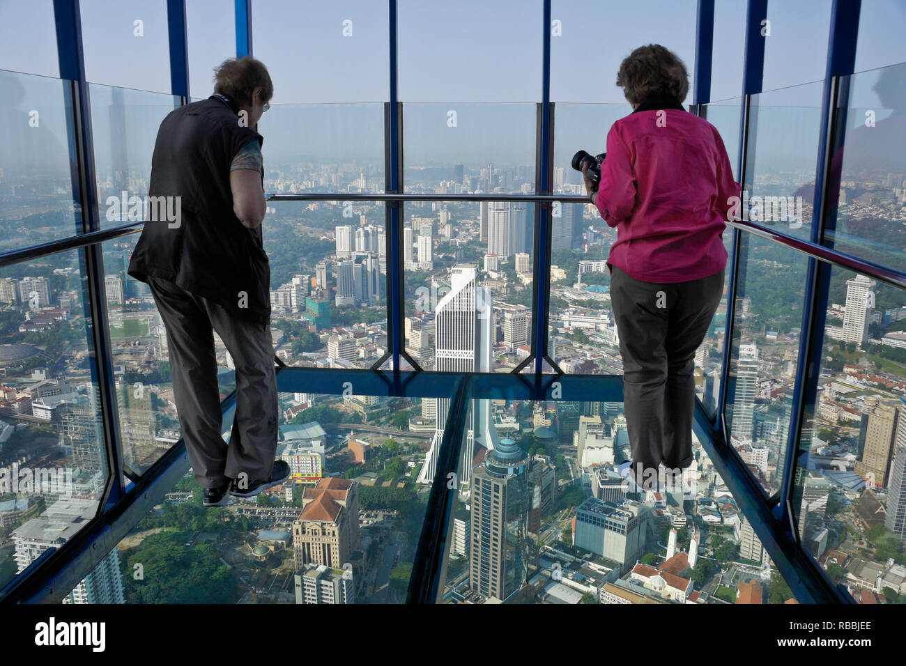 Tourists standing in glass Sky Box of KL Tower Sky Deck, Kuala Lumpur ...