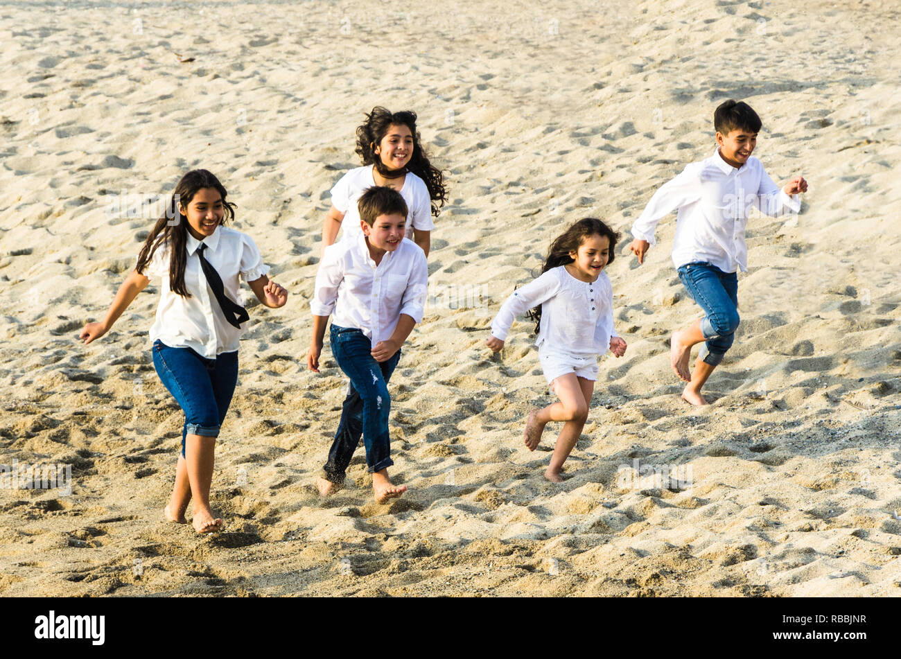 Kid running along beach hi-res stock photography and images - Alamy
