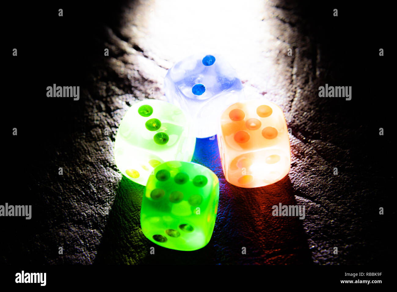 Dices of several colors, red, green, blue and black and white with soft ...