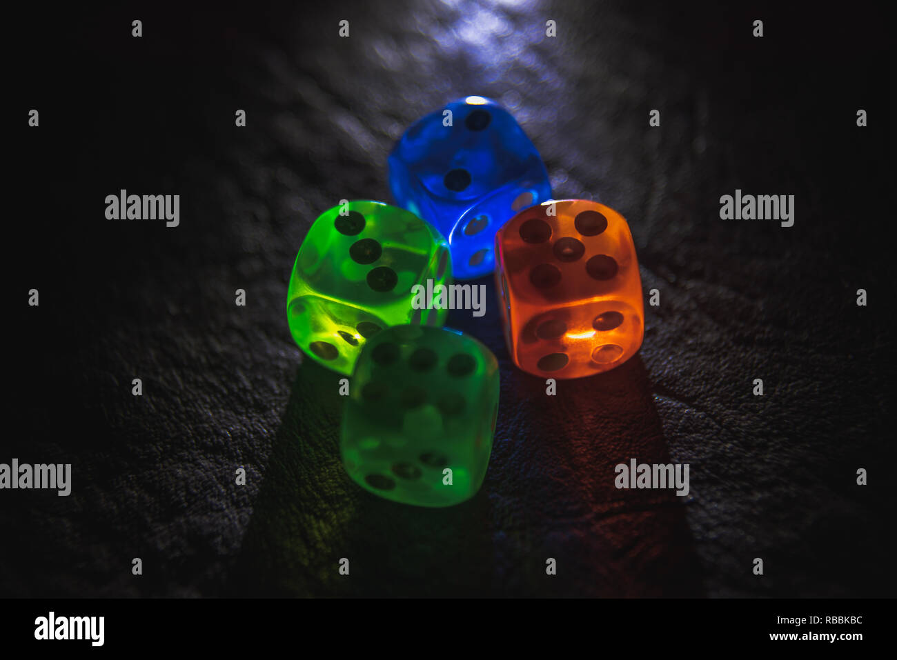 Dices of several colors, red, green, blue and black and white with soft ...