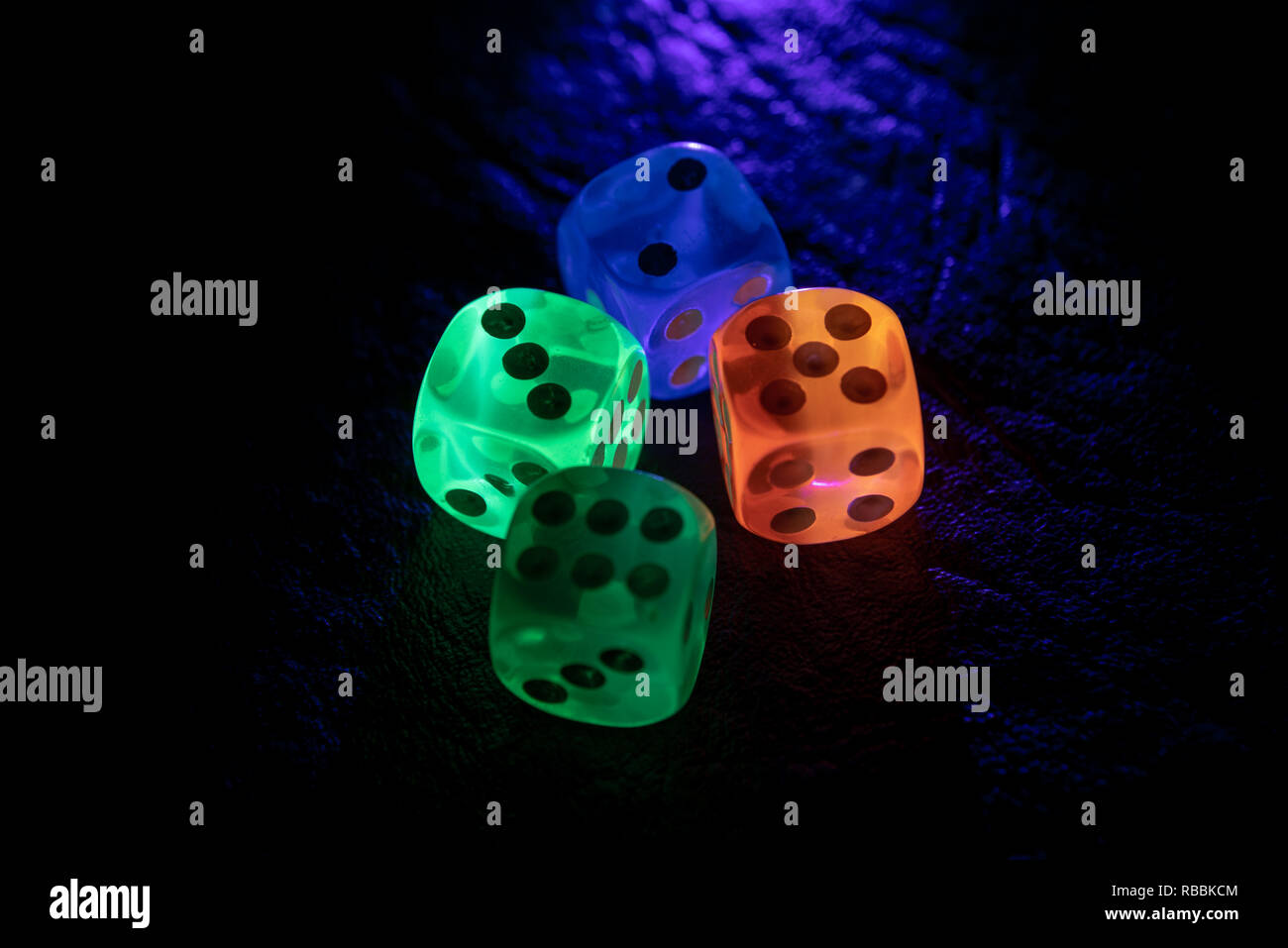 Dices of several colors, red, green, blue and black and white with soft ...