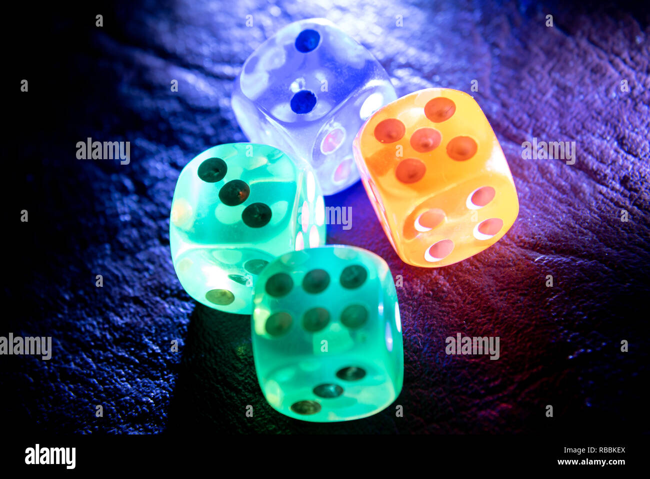 Dices of several colors, red, green, blue and black and white with soft ...