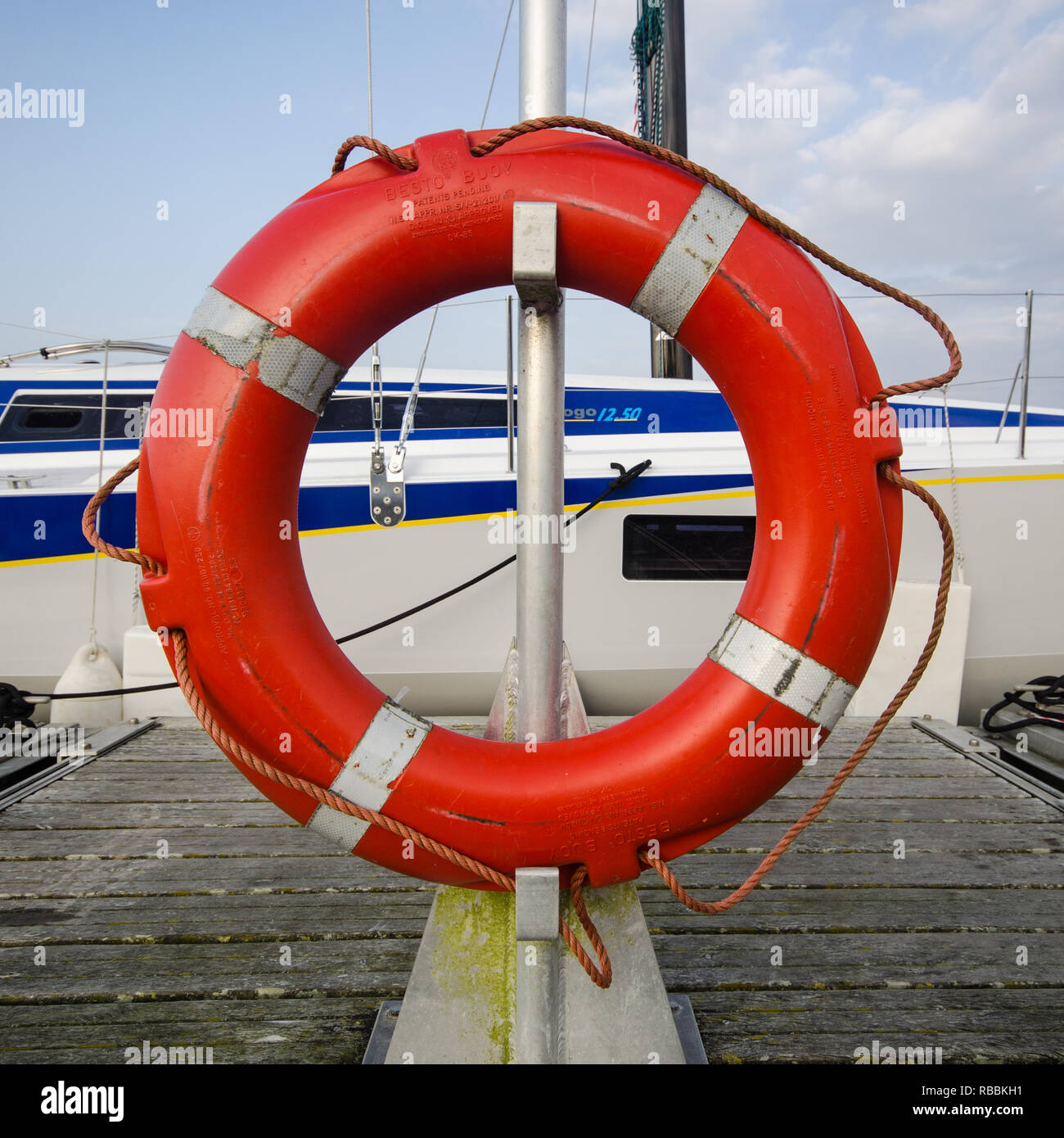 Orange safety ring lifebuoy on holder Stock Photo - Alamy