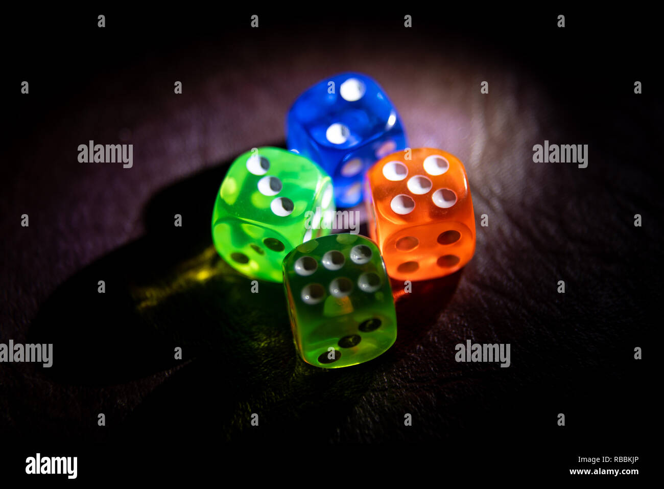 Dices of several colors, red, green, blue and black and white with soft ...