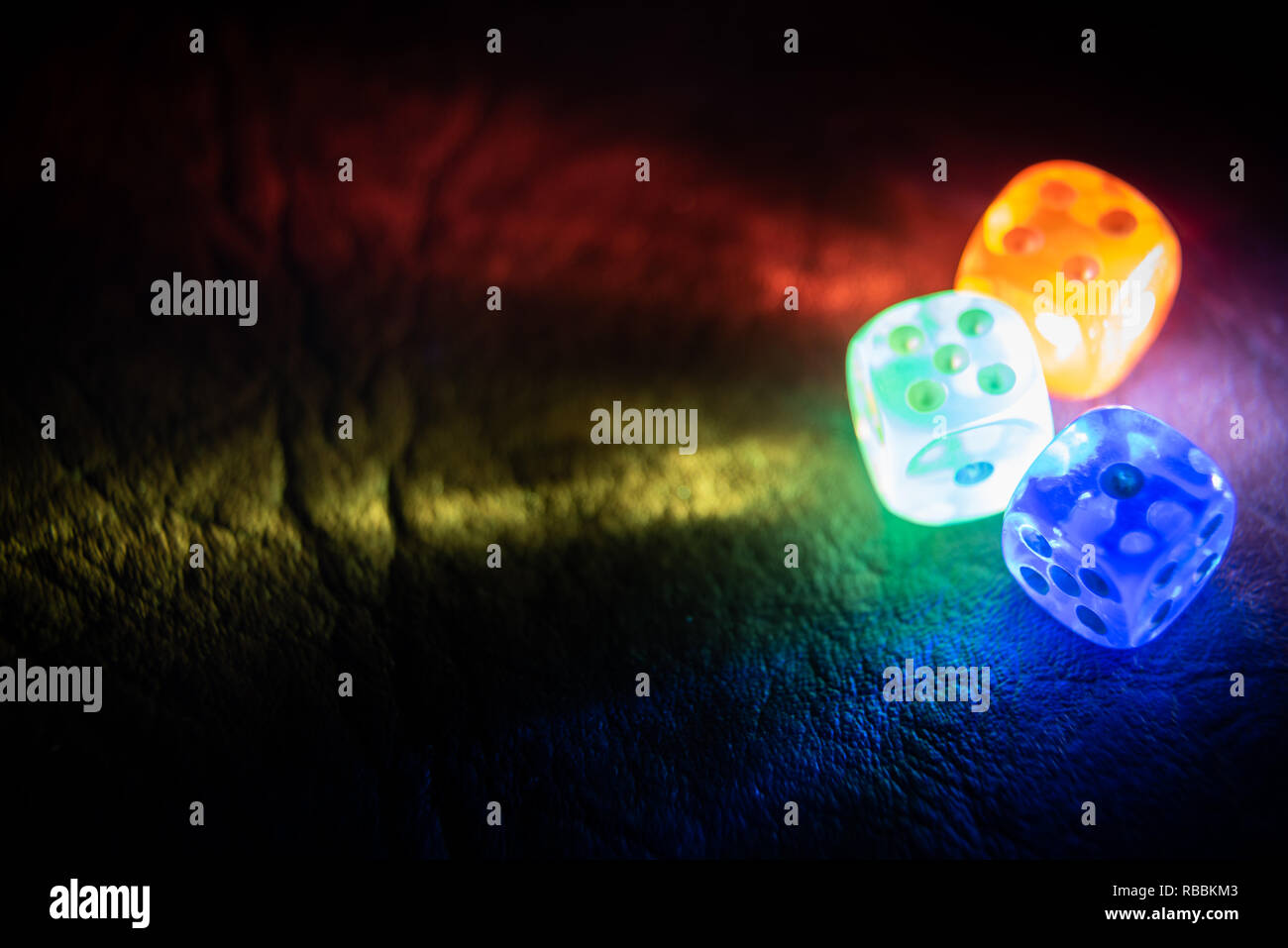 Dices of several colors, red, green, blue and black and white with soft ...