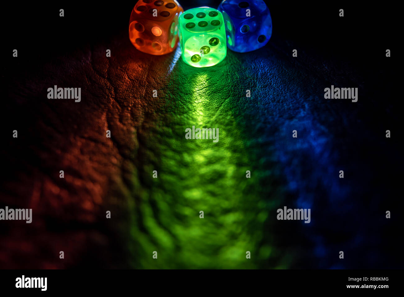 Dices of several colors, red, green, blue and black and white with soft ...