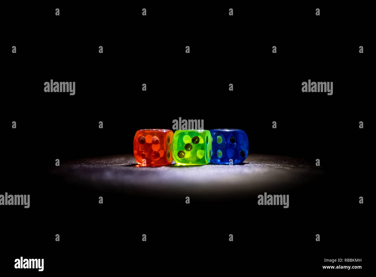 Dices of several colors, red, green, blue and black and white with soft ...