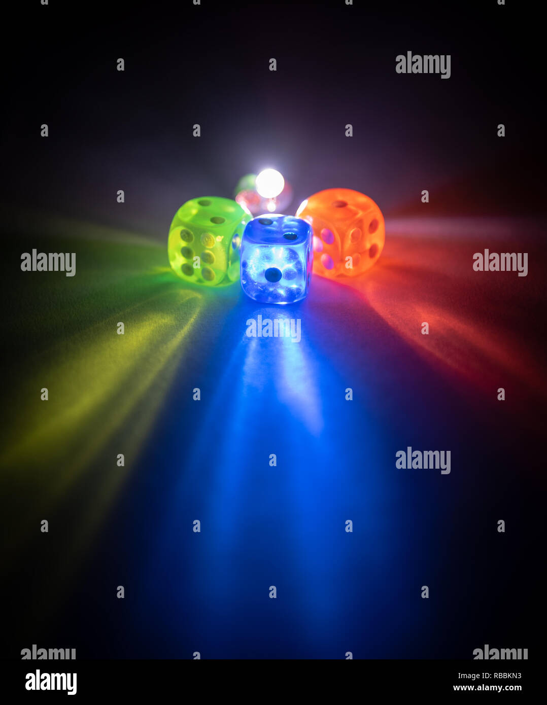 Dices of several colors, red, green, blue and black and white with soft ...