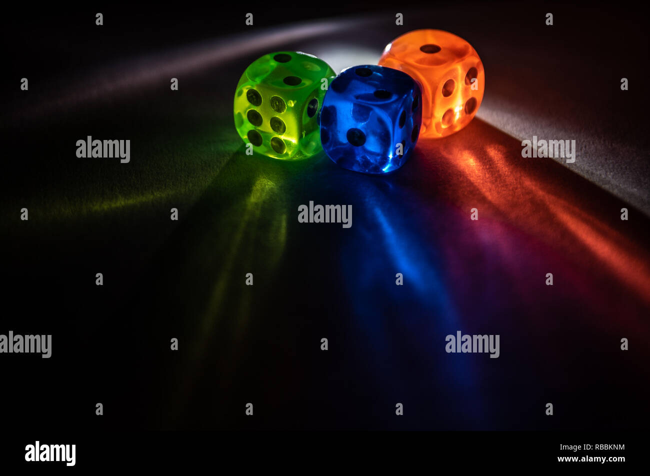 Dices of several colors, red, green, blue and black and white with soft ...