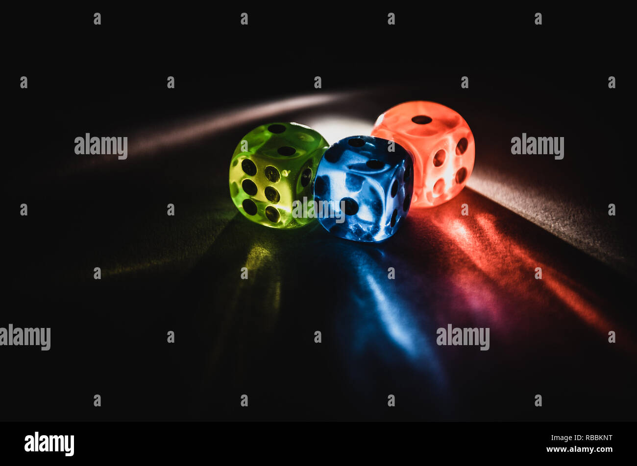 Dices of several colors, red, green, blue and black and white with soft ...