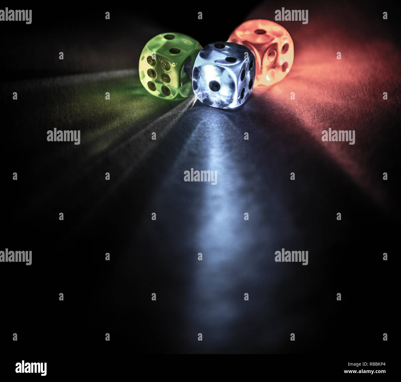 Dices of several colors, red, green, blue and black and white with soft ...