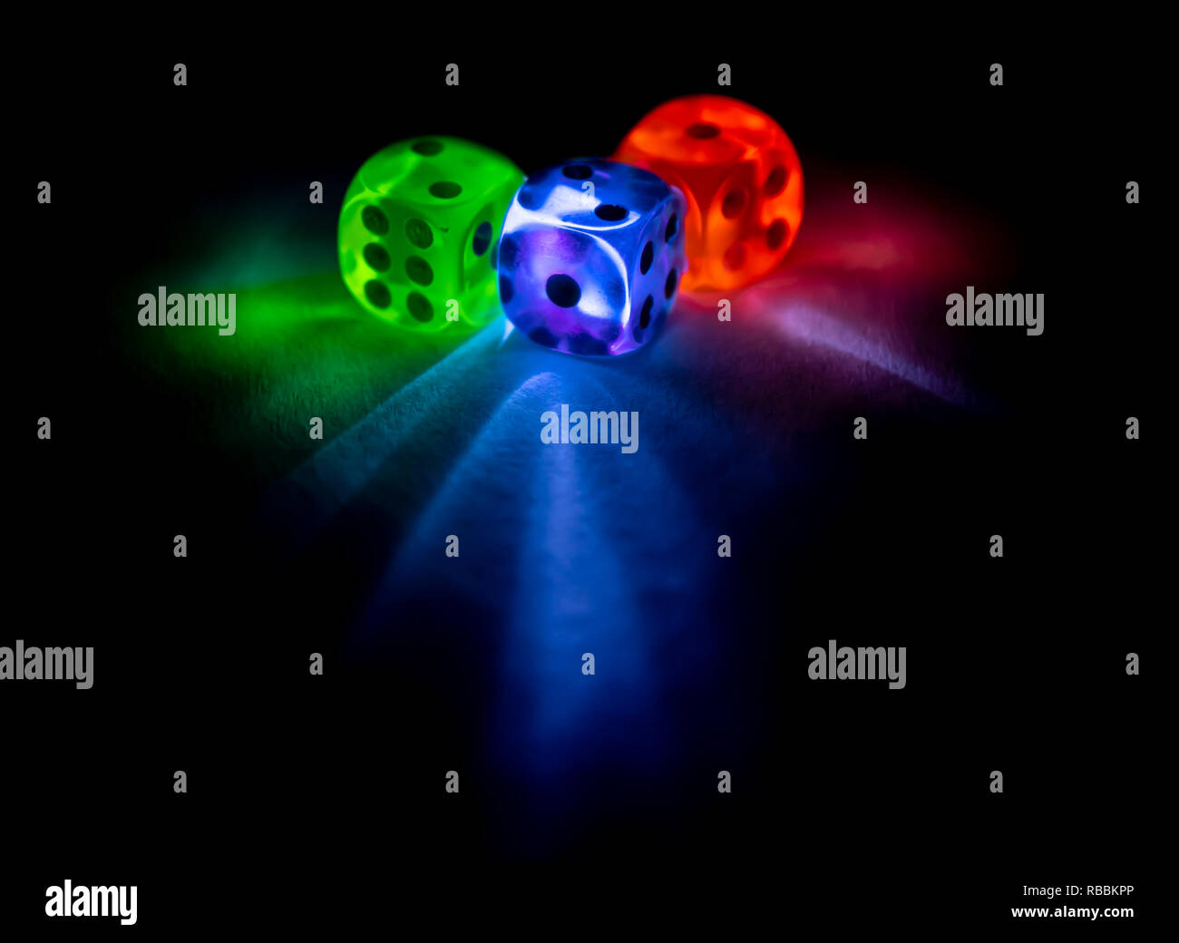 Dices of several colors, red, green, blue and black and white with soft ...