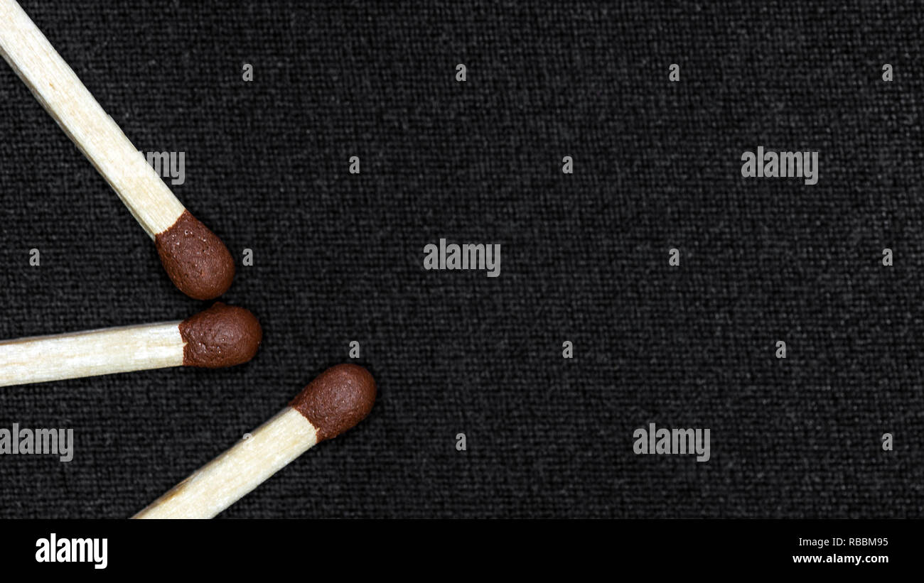 Scattered matches on a black background Stock Photo - Alamy