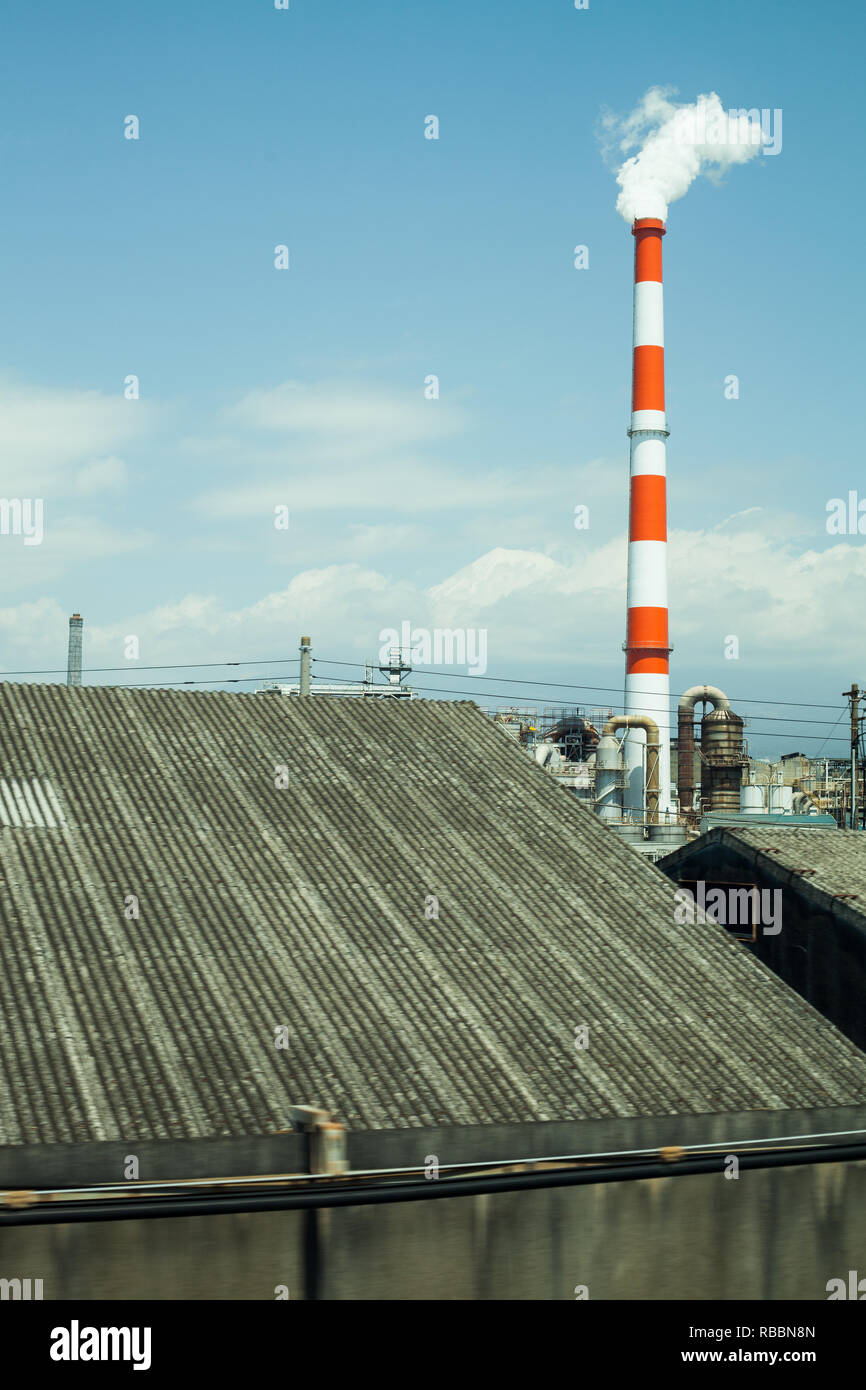 Industrial skyline in Japan with striped chimney Stock Photo - Alamy