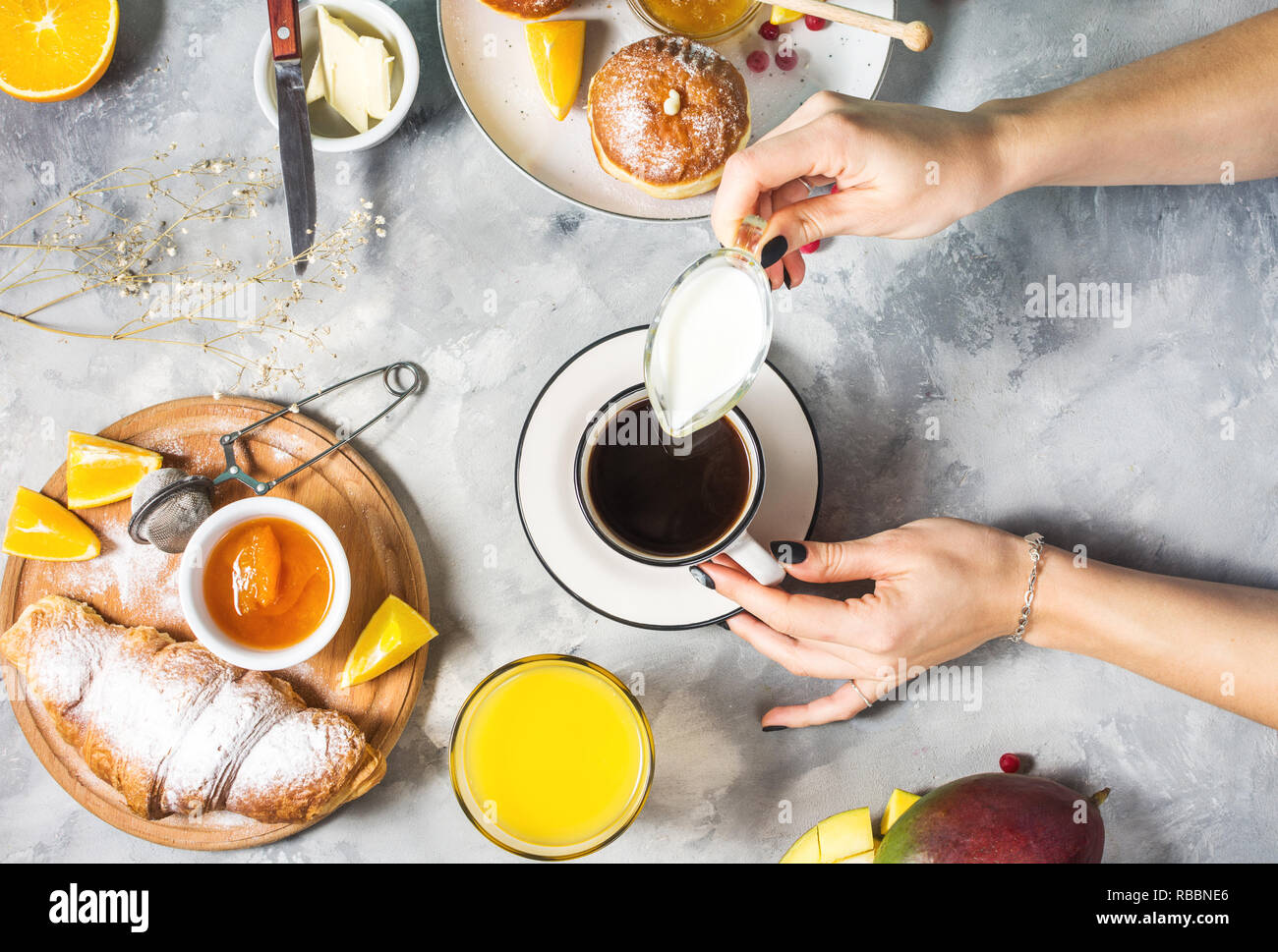 Female hands. Breakfast served with coffee, orange juice, croissants ...
