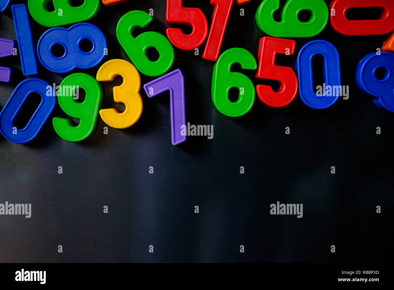 Colorful magnetic numbers and letters grouped on the fridge Stock Photo ...