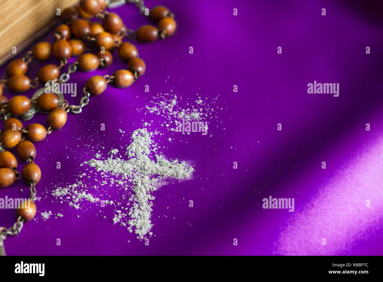 Ash Wednesday religion concept on violet fabric background with rosary ...