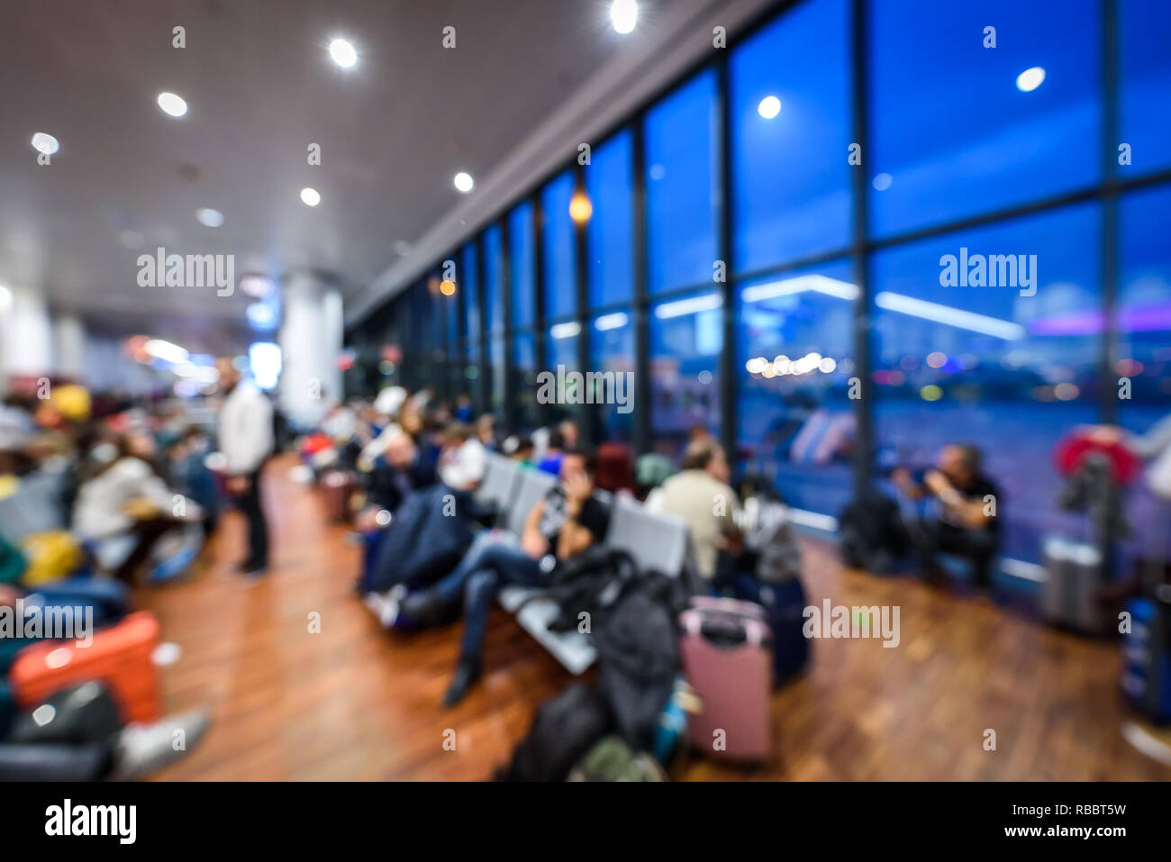 Abstract blurred picture of passengers waiting on the airport. Crowded ...