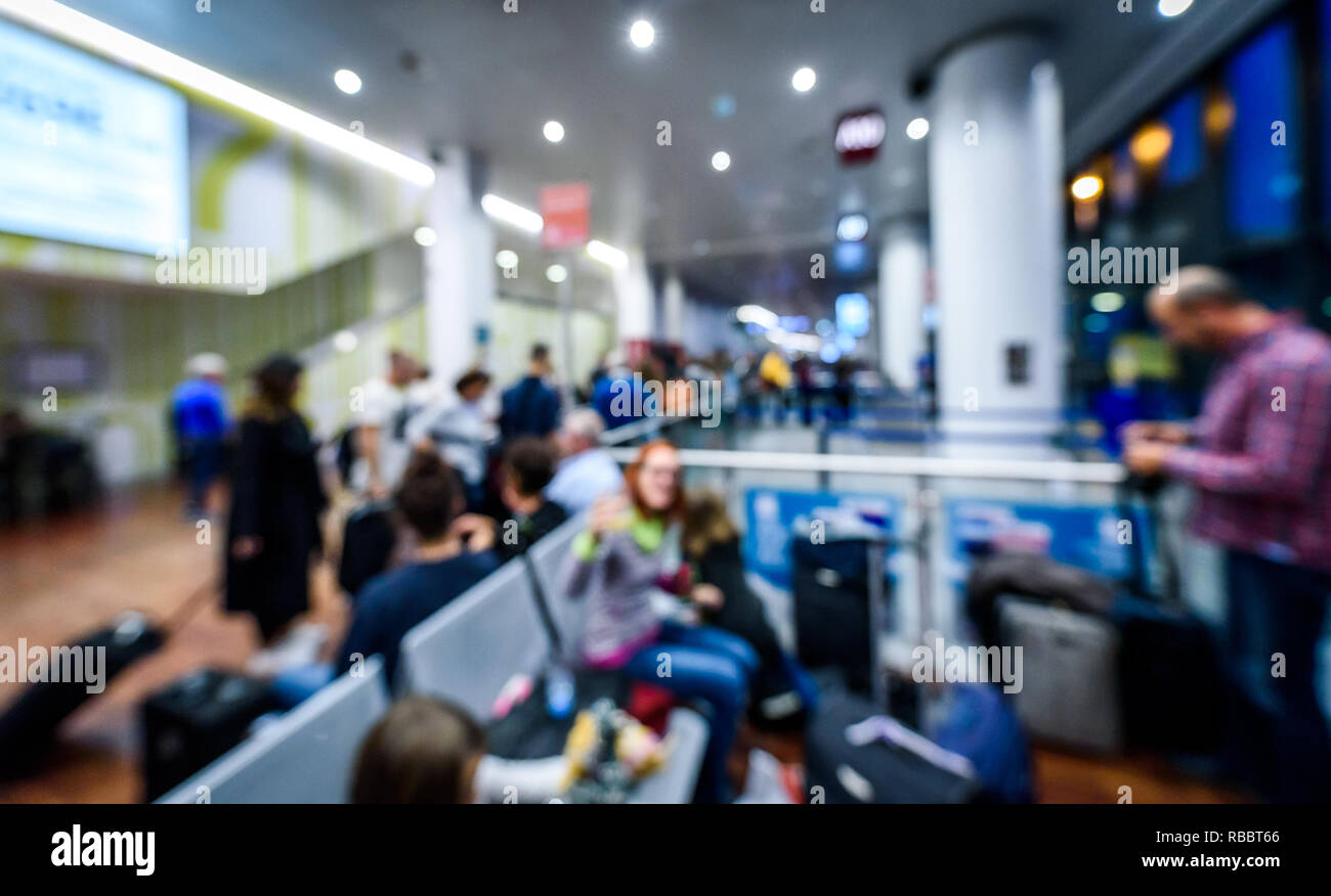 Abstract blurred picture of passengers waiting on the airport. Crowded ...