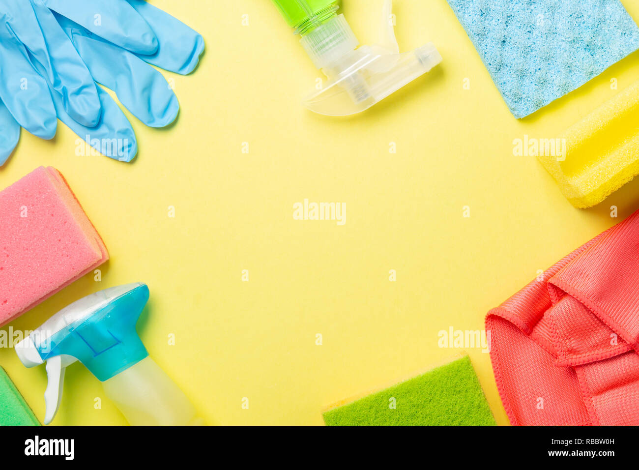 Cleaning concept - cleaning supplies on pastel yellow background Stock ...