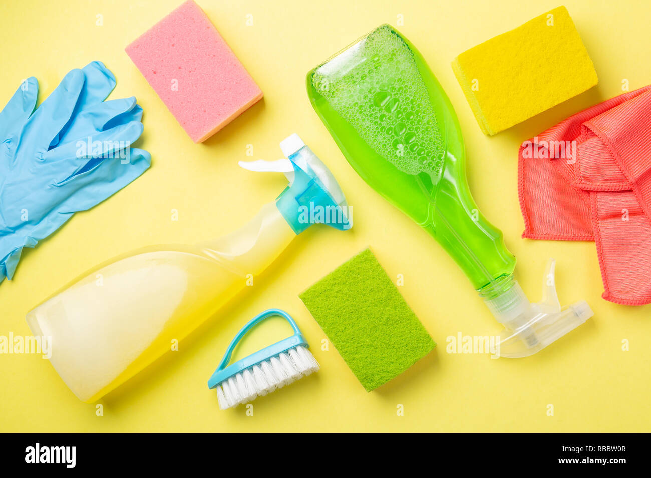 Cleaning concept - cleaning supplies on pastel yellow background Stock ...