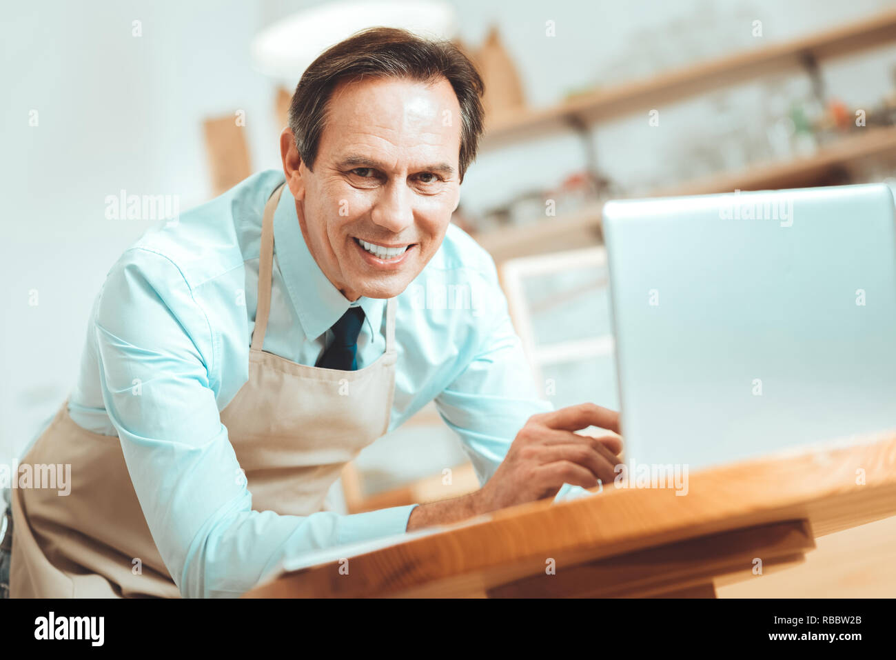 Online business. Business man receiving orders in internet using laptop ...