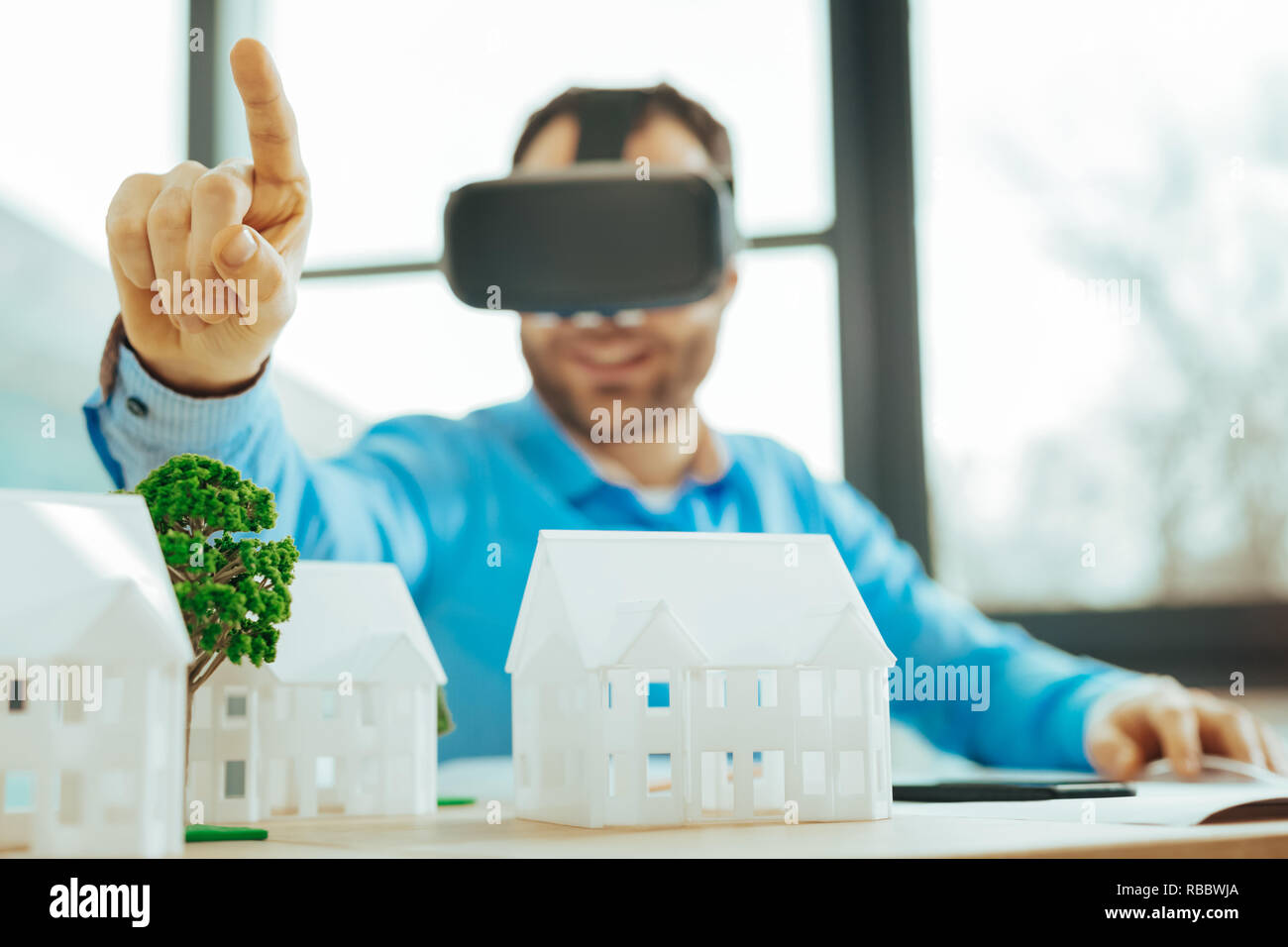 Pointing. Clever professional engineer making a research and smiling ...